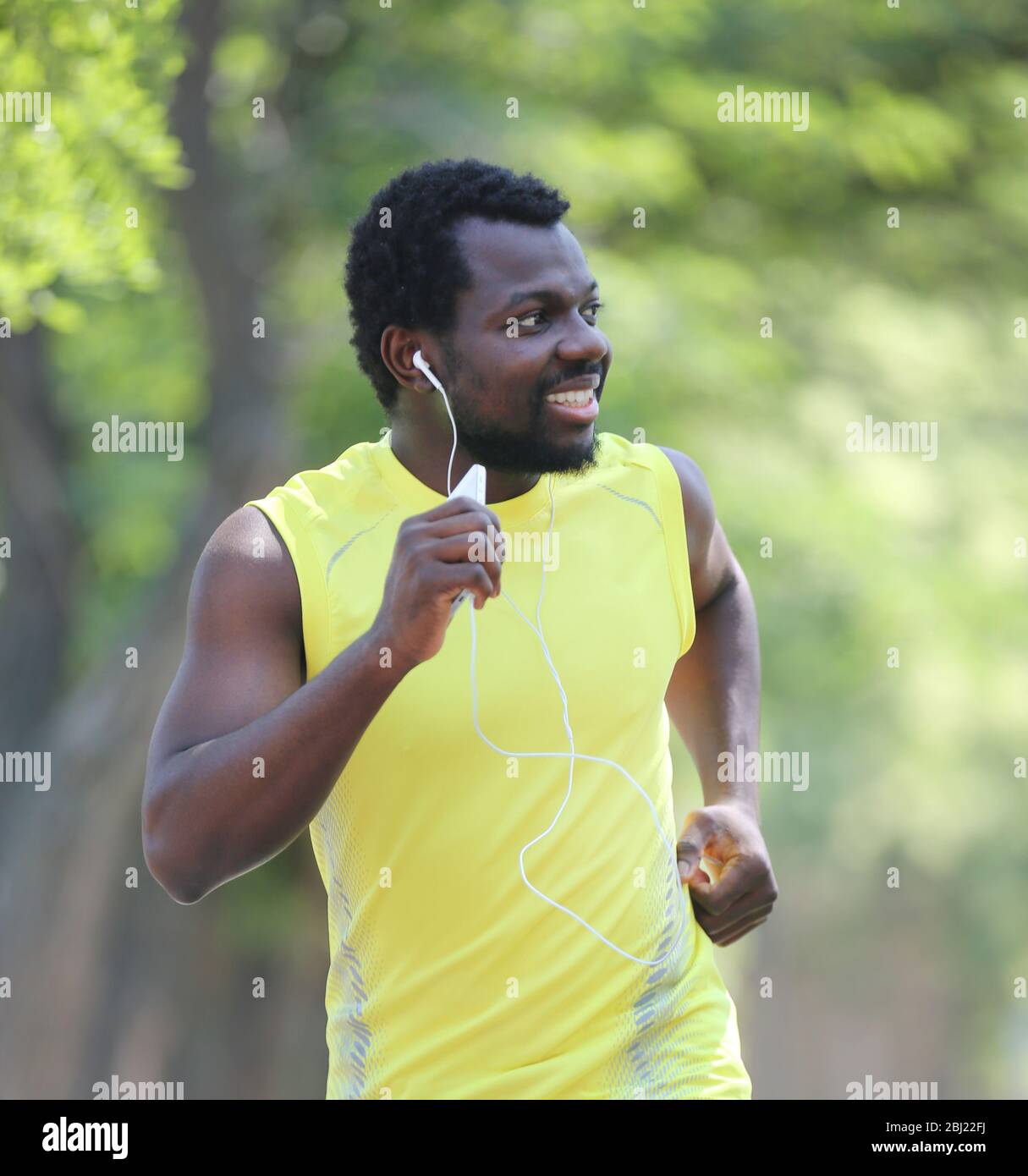 African American young man jogging in park Stock Photo - Alamy