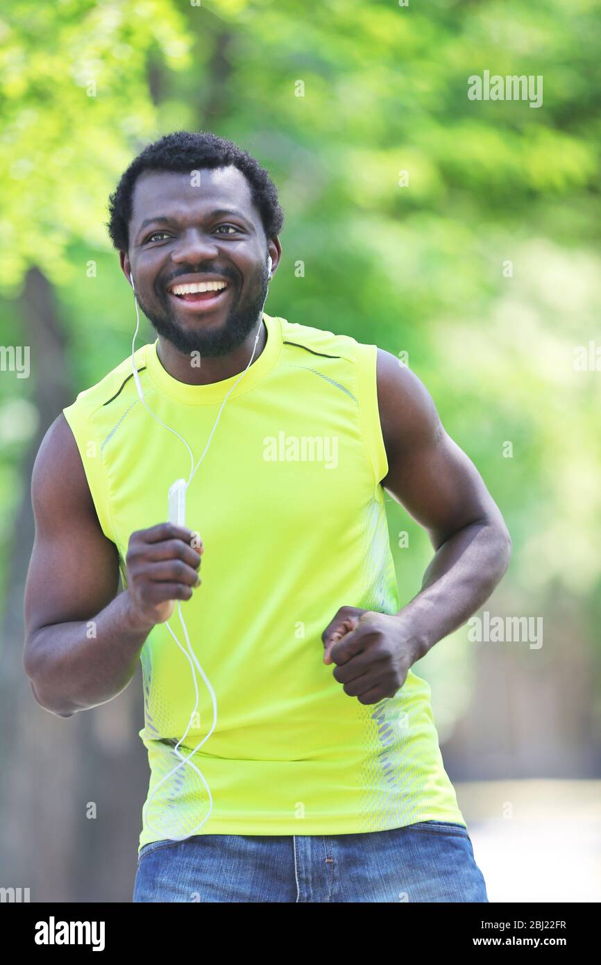 African American young man jogging in park Stock Photo - Alamy