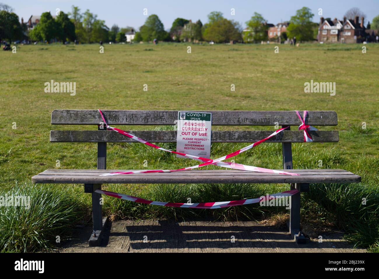 A bench on Wimbledon Common taped up to stop people sitting upon it ...