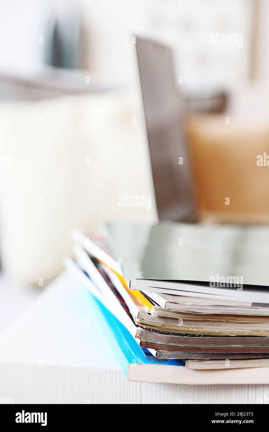 Magazines and laptop on table in living room, close up Stock Photo - Alamy