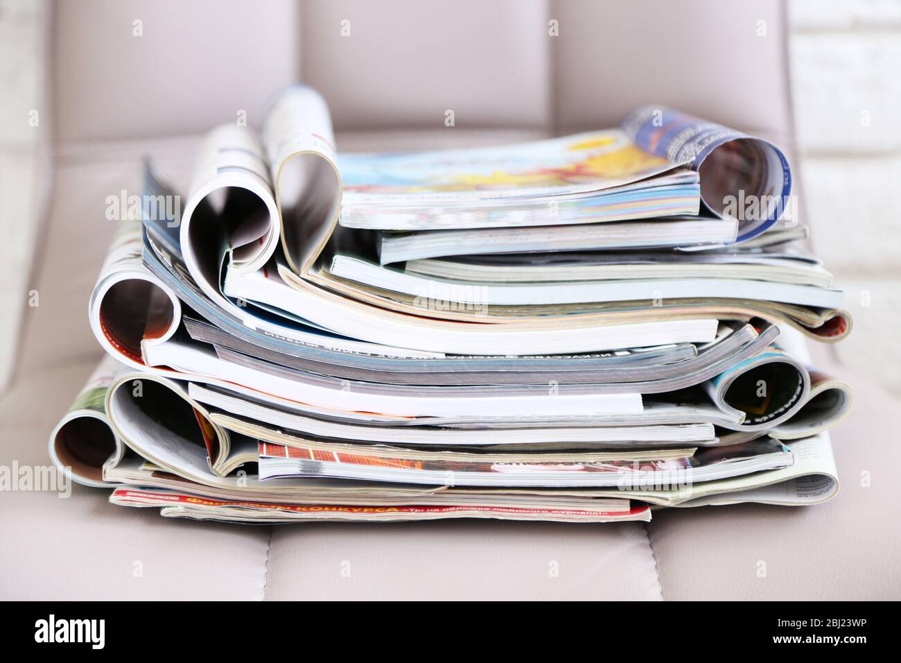 Stack of magazines on chair, close up Stock Photo - Alamy