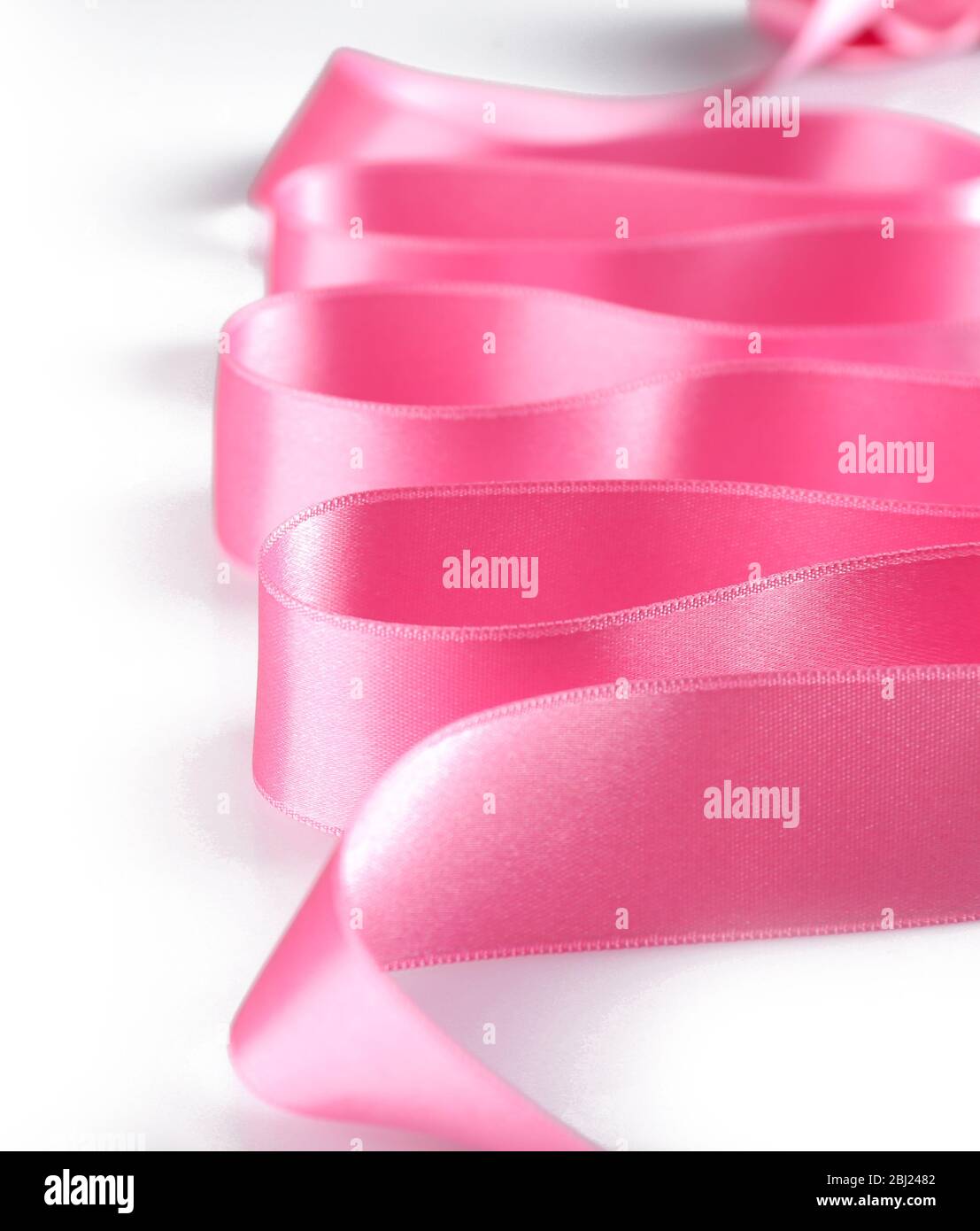 Pink silk ribbon isolated on white Stock Photo - Alamy