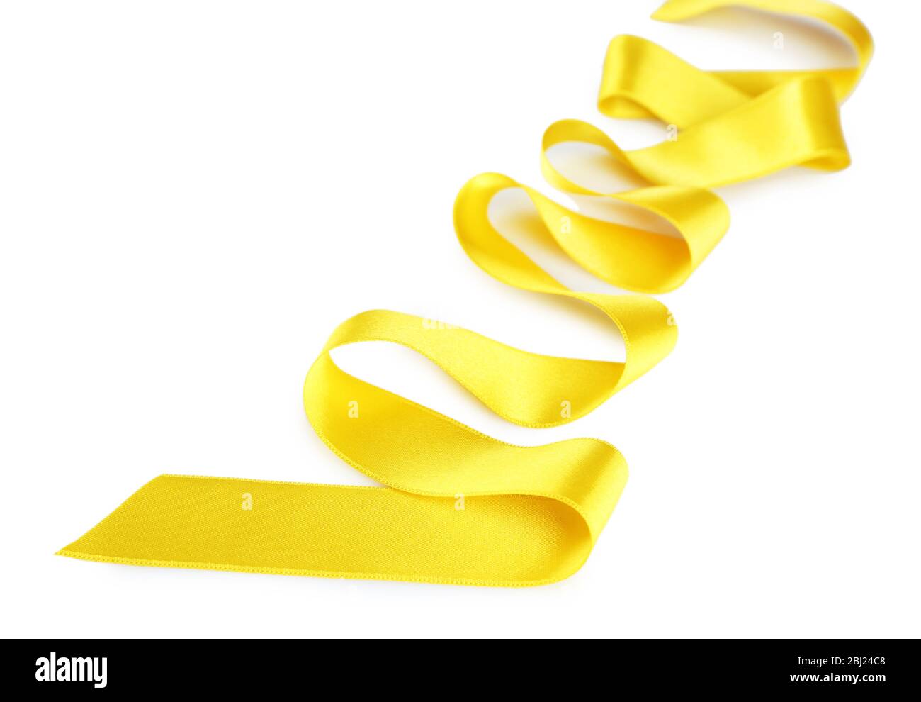 Yellow silk ribbon isolated on white Stock Photo - Alamy