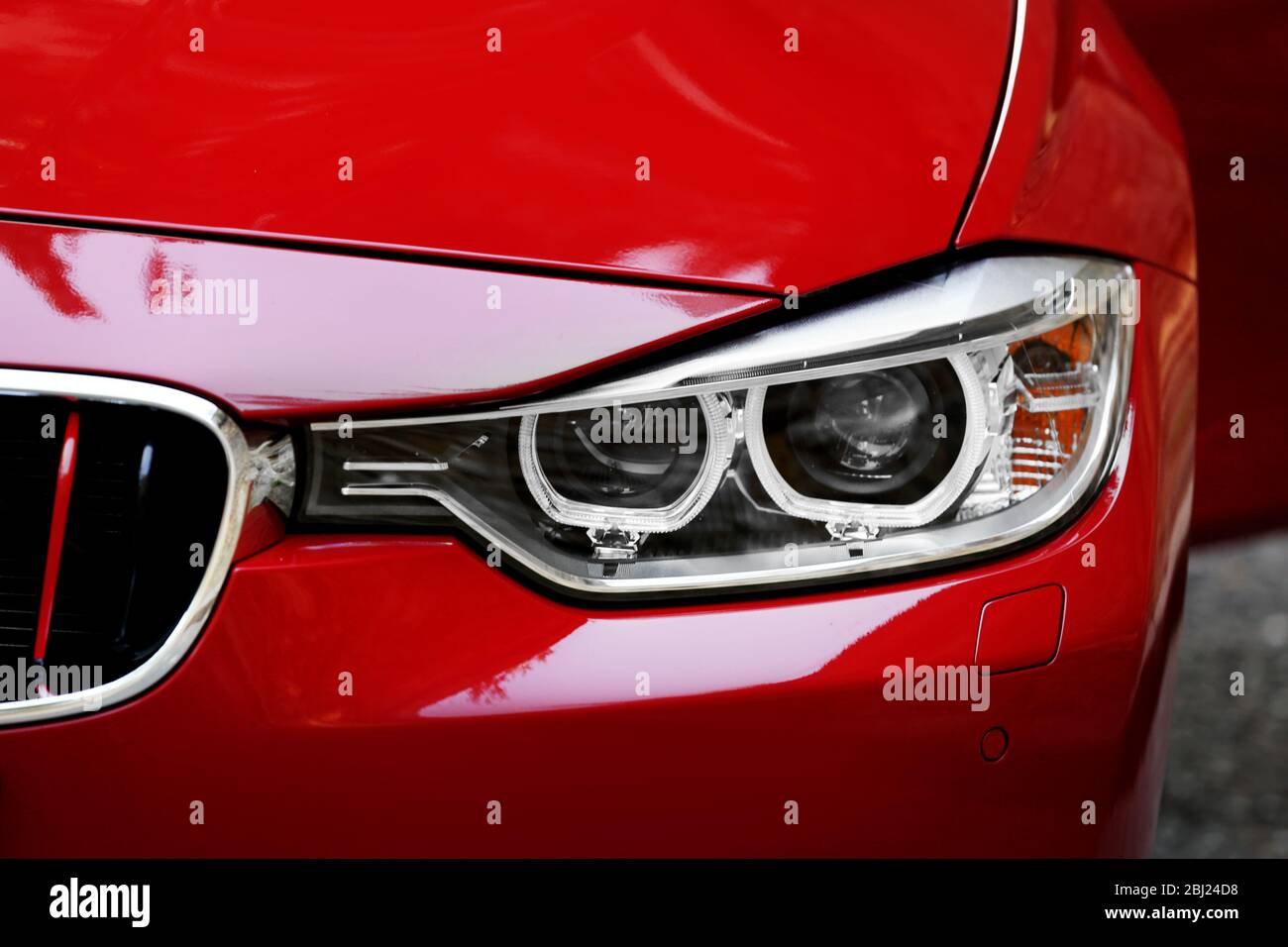 Headlights of red car Stock Photo - Alamy