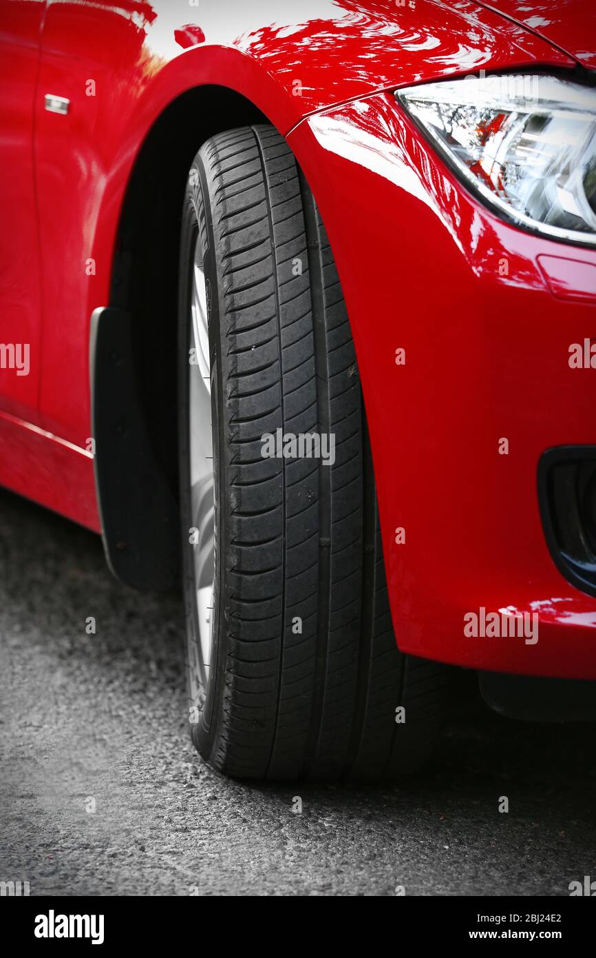 Wheel of red car, outdoors Stock Photo - Alamy