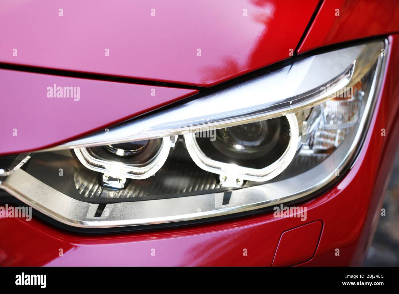 Headlights of red car Stock Photo - Alamy