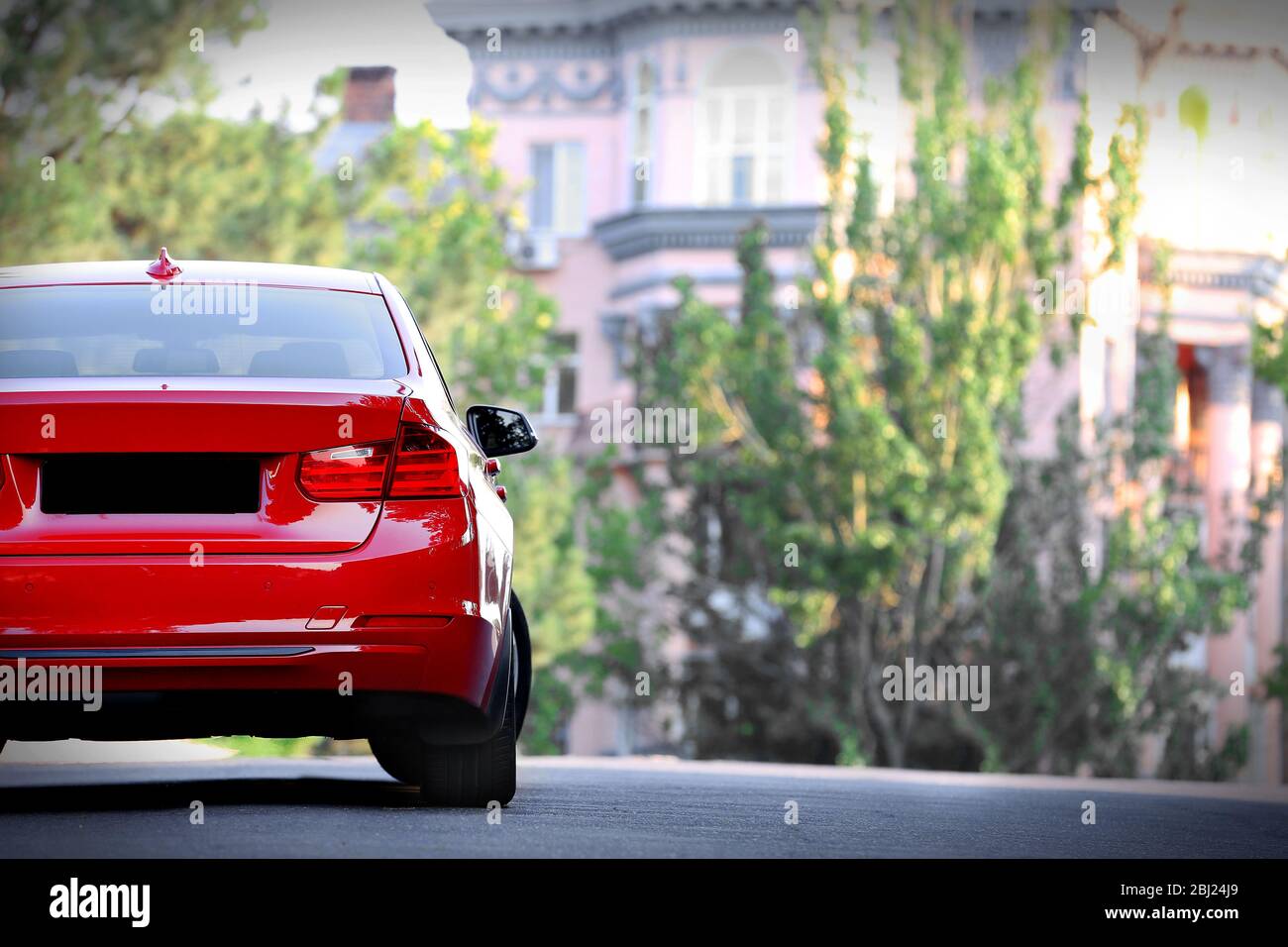 Red car on road Stock Photo - Alamy