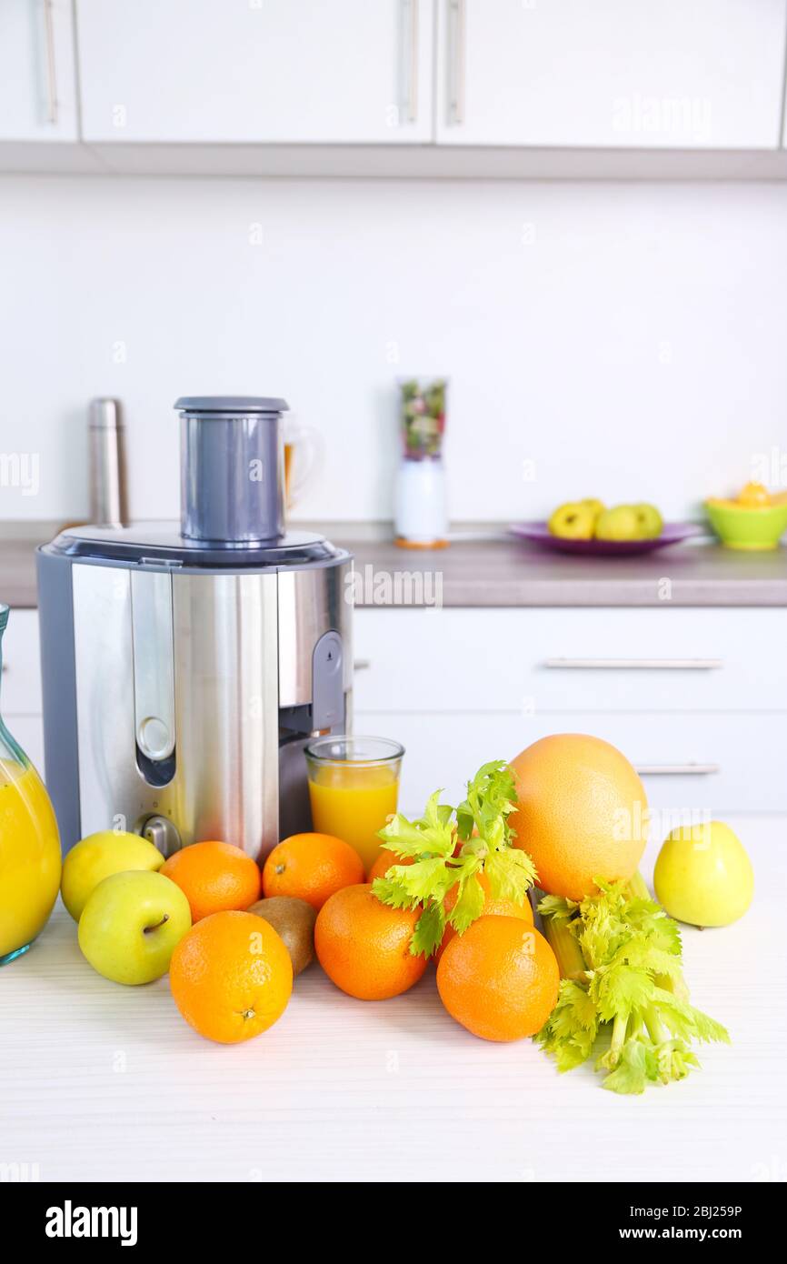 Juicer and fruits on table in kitchen, close up Stock Photo - Alamy