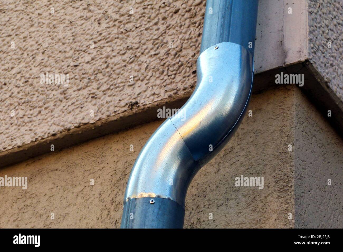 Shiny new zink down pipe, rain water leader transfer S elbow installed ...
