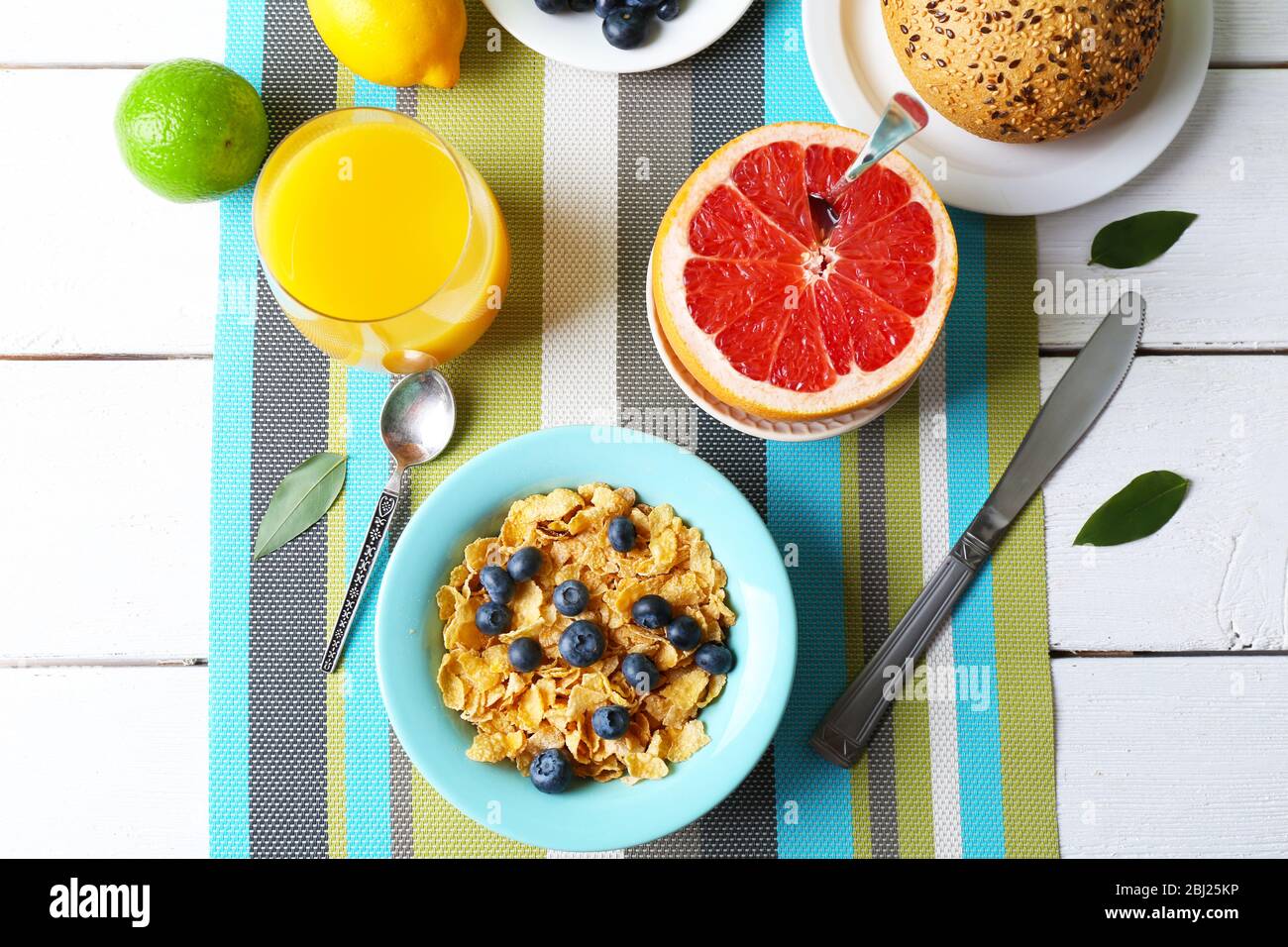 Tasty cornflakes with fruits and berries on table close up Stock Photo ...