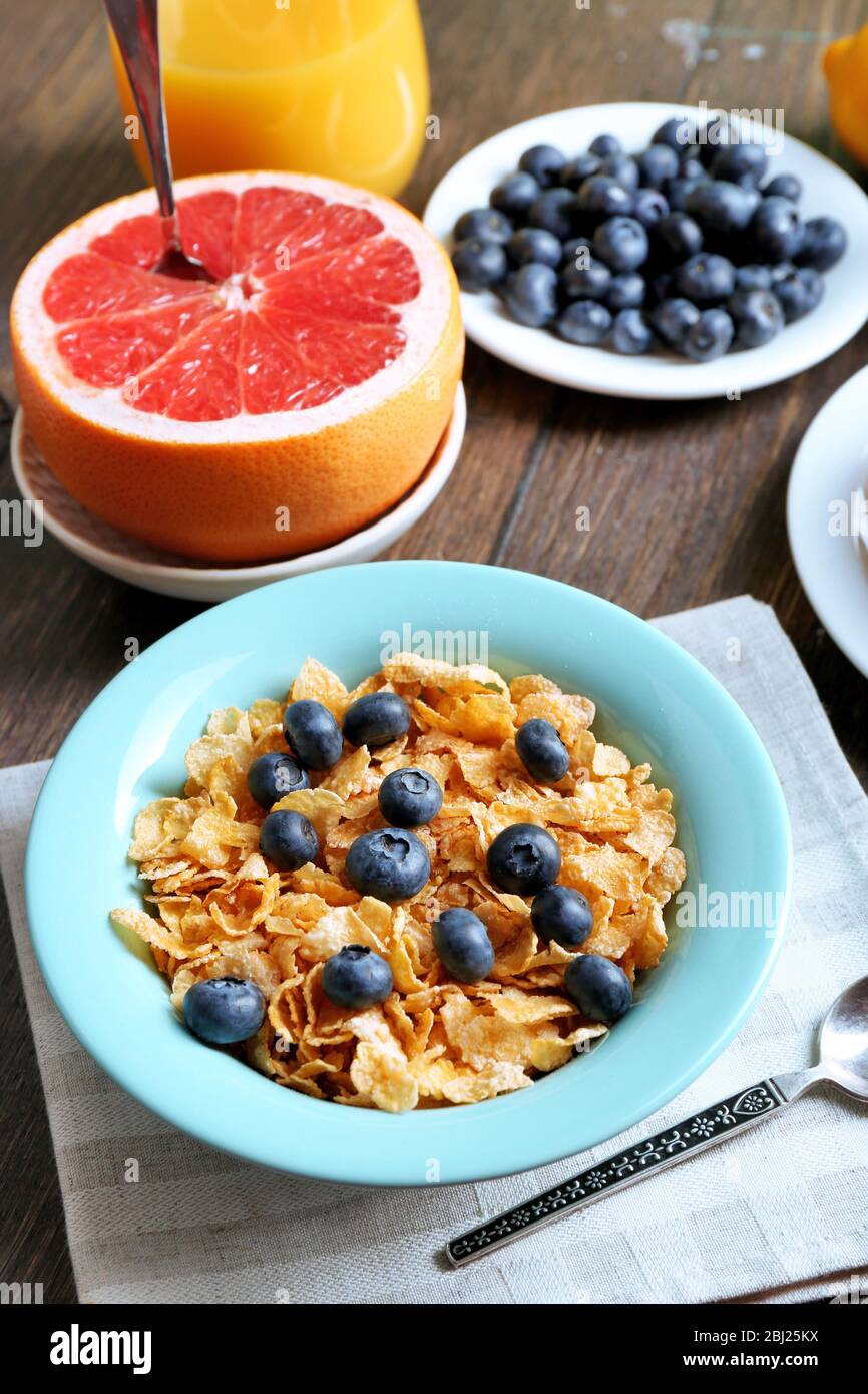 Tasty cornflakes with fruits and berries on table close up Stock Photo ...