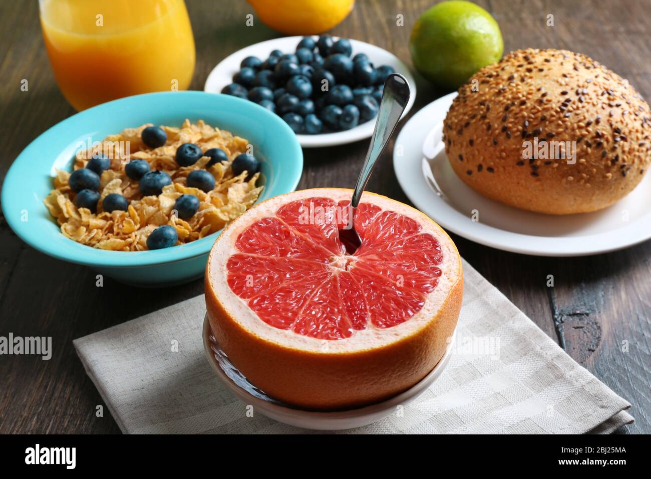 Tasty cornflakes with fruits and berries on table close up Stock Photo ...