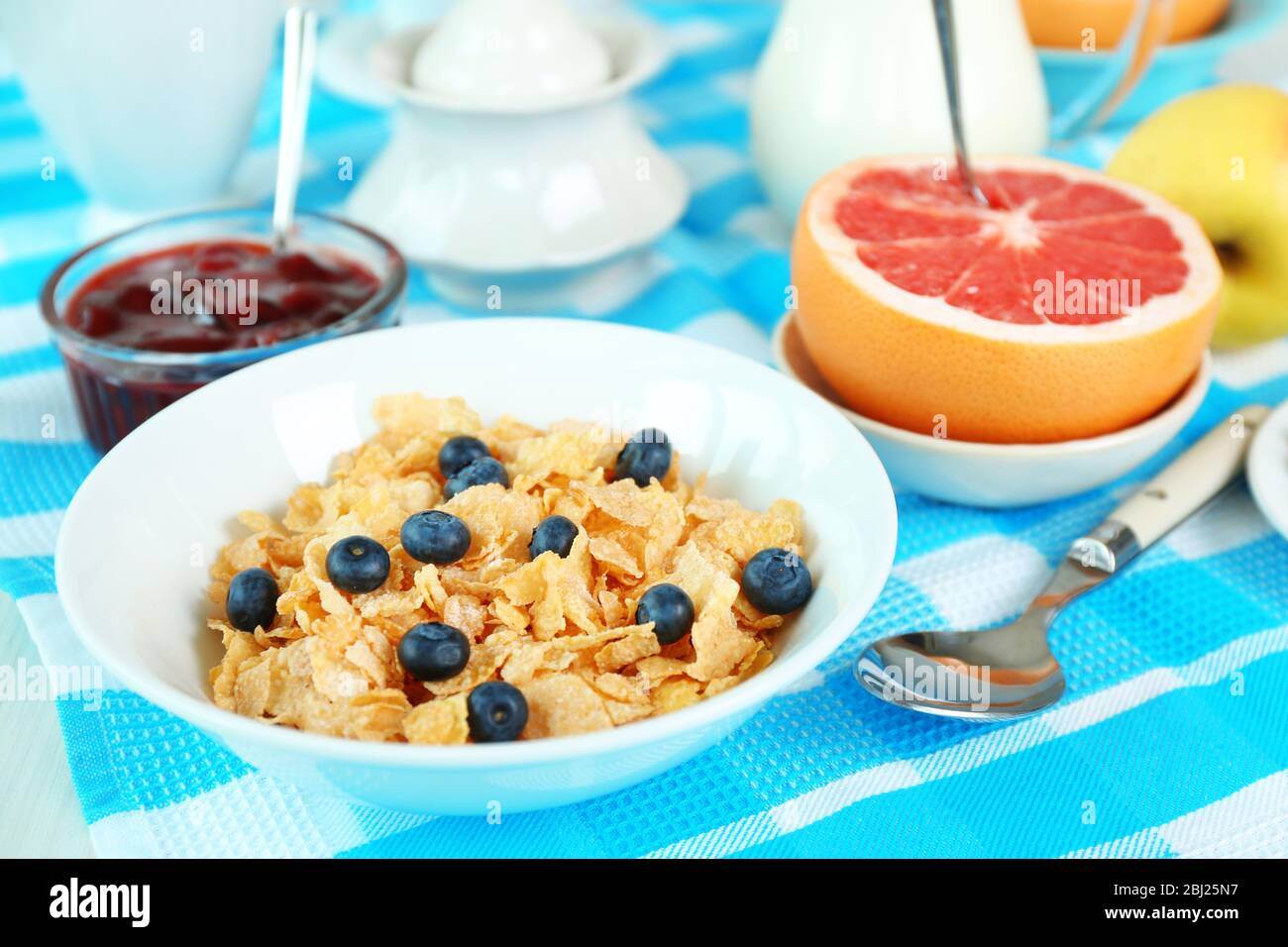 Tasty cornflakes with fruits and berries on table close up Stock Photo ...