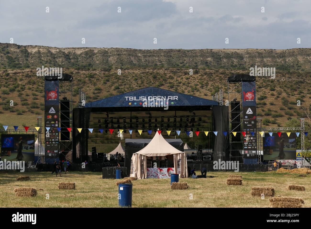 Audience with hands raised at a music festival and lights streaming ...