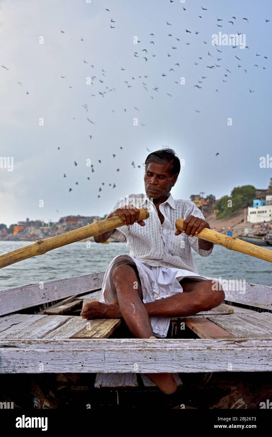 Oarsman on the a boat ride in Ganges, Varanasi Stock Photo - Alamy