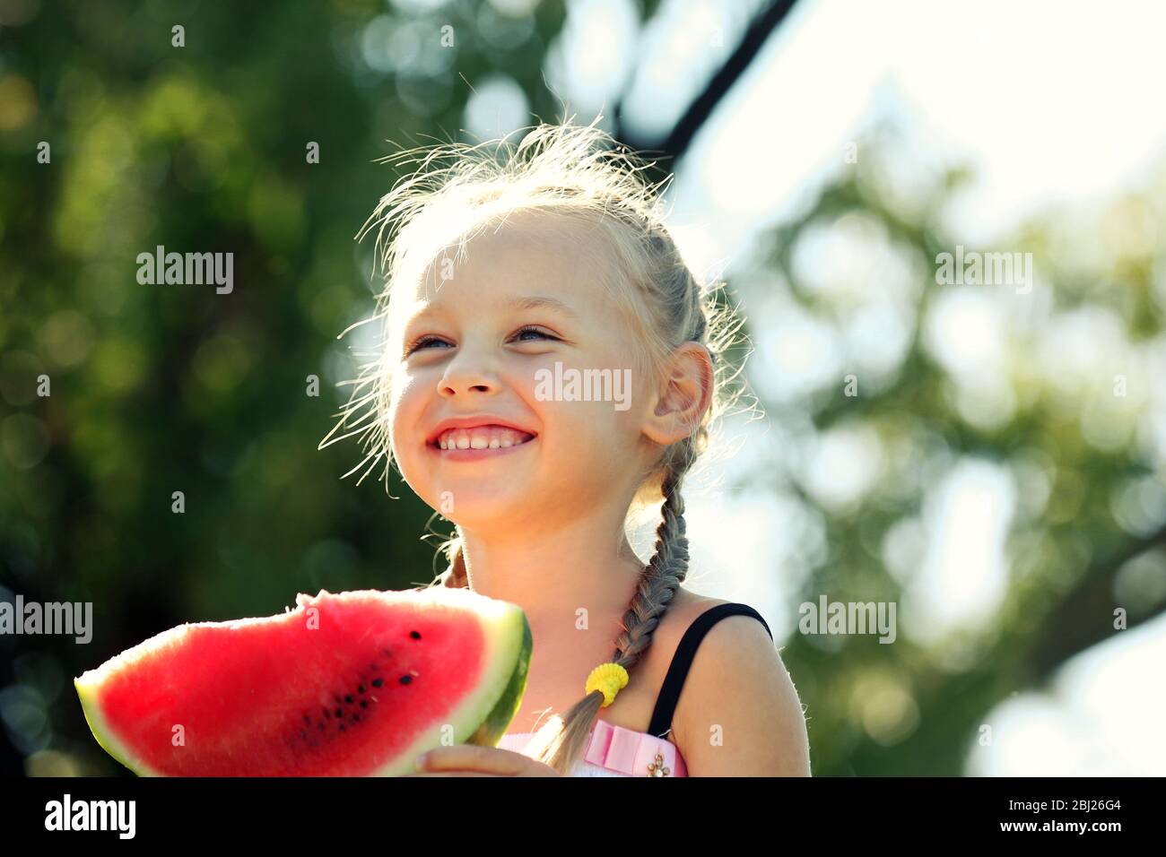 Small girl eating watermelons outdoors Stock Photo - Alamy