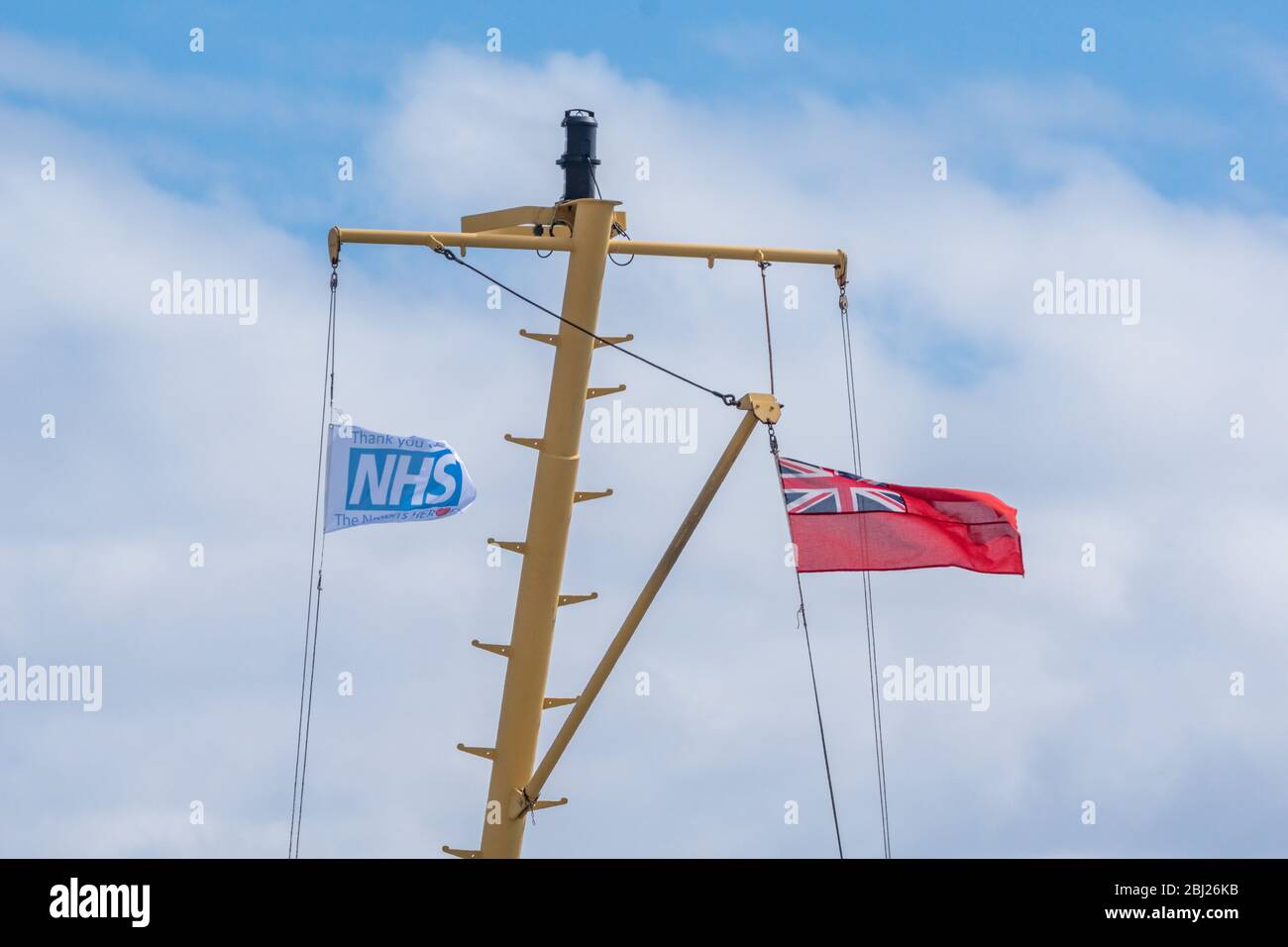 NHS, Thank you heroes flag, with red ensign flying on mast on Calmac ...