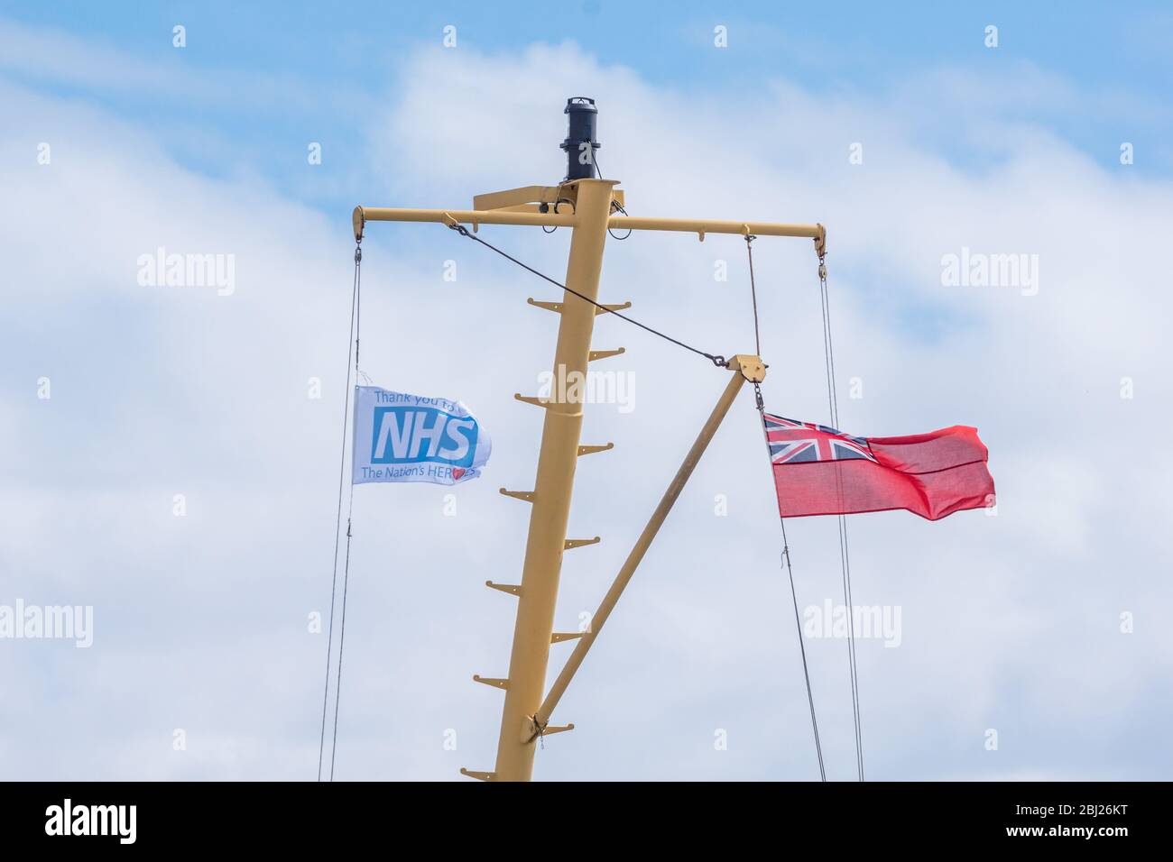 NHS, Thank you heroes flag, with red ensign flying on mast on Calmac ...