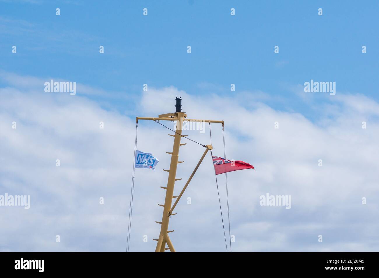 NHS, Thank you heroes flag, with red ensign flying on mast on Calmac ...