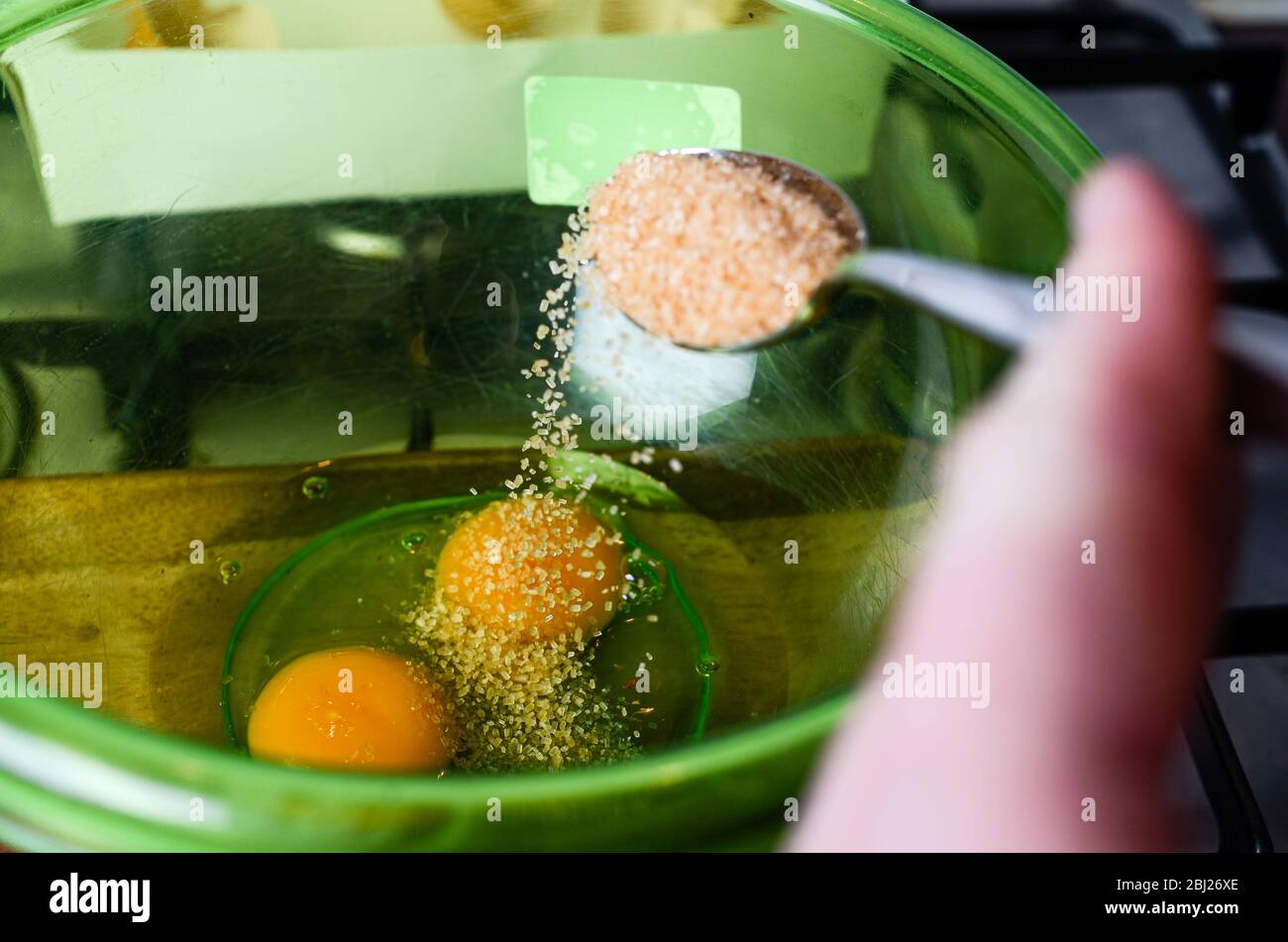Mxing eggs with sugar , flour and butter to bake a cake Stock Photo - Alamy