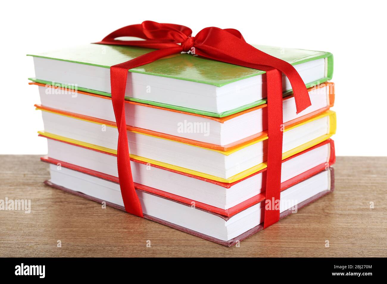 Stack of books with ribbon on light background Stock Photo - Alamy