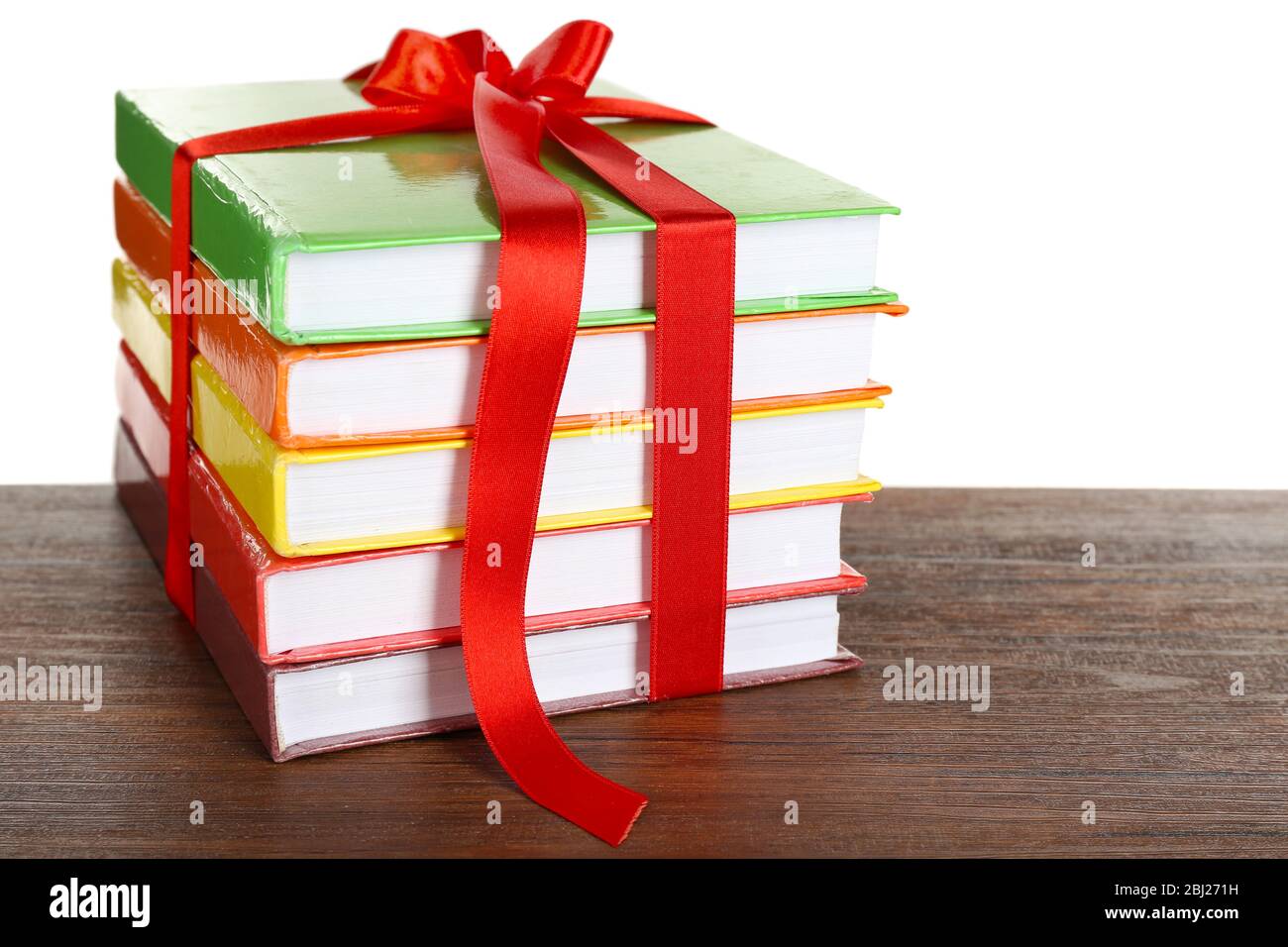 Stack of books with ribbon on light background Stock Photo - Alamy