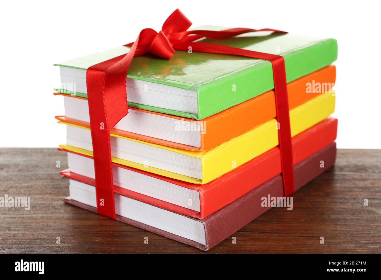 Stack of books with ribbon on light background Stock Photo - Alamy