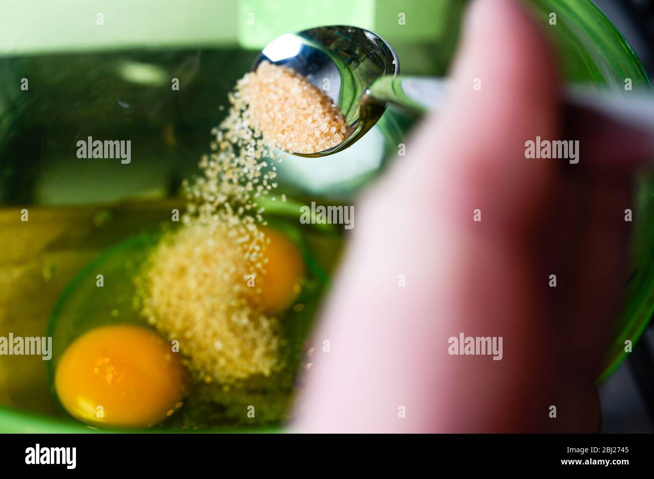 Mxing eggs with sugar , flour and butter to bake a cake Stock Photo - Alamy
