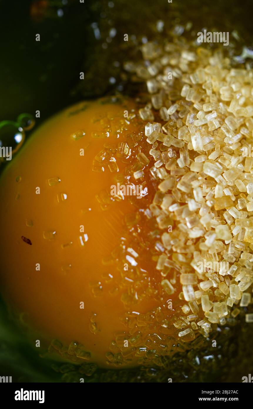 Mxing eggs with sugar , flour and butter to bake a cake Stock Photo - Alamy