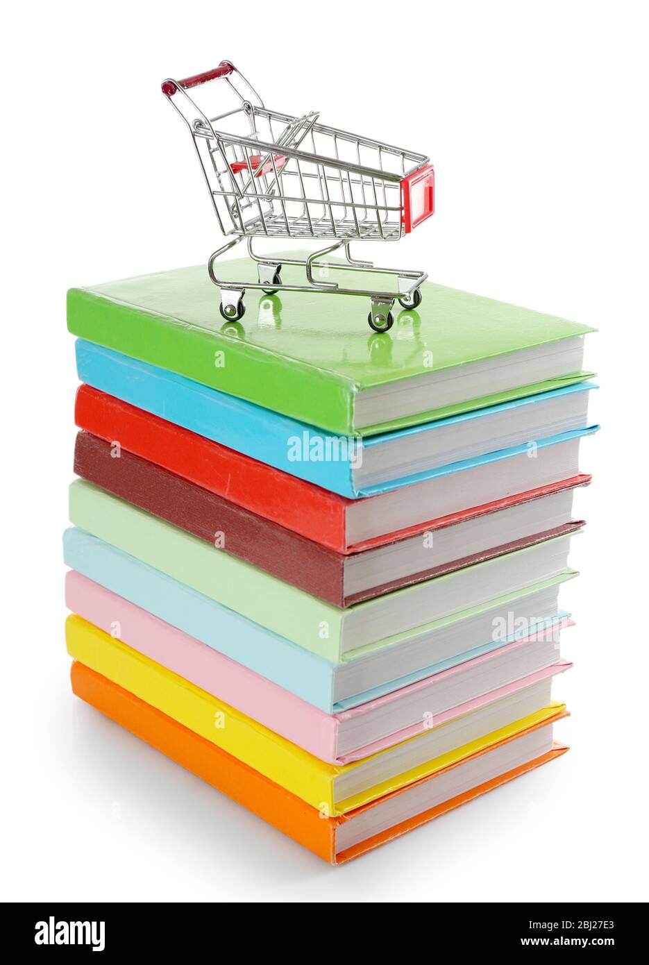 Stack of colorful books with small shopping cart isolated on white ...
