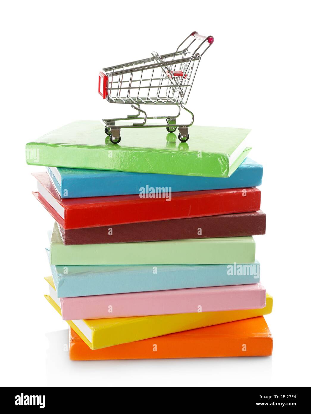 Stack of colorful books with small shopping cart isolated on white ...