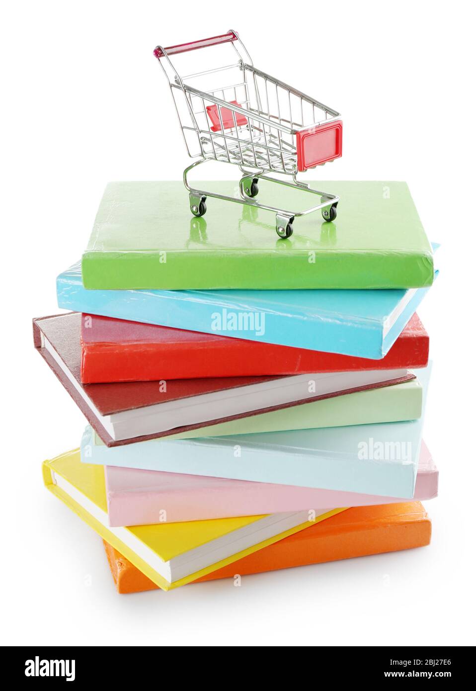 Stack of colorful books with small shopping cart isolated on white ...