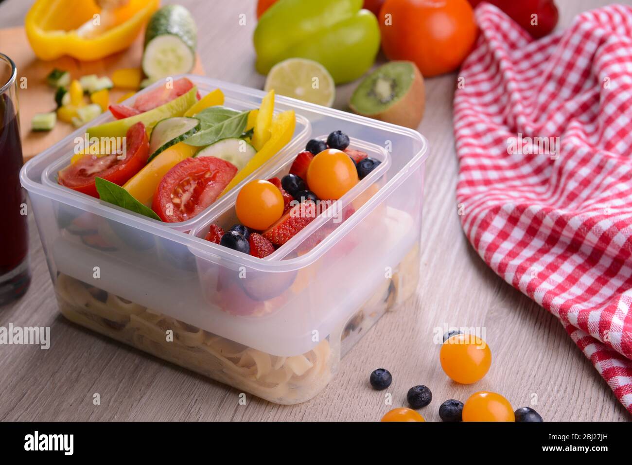 Tasty lunch in plastic containers on wooden table close up Stock Photo ...