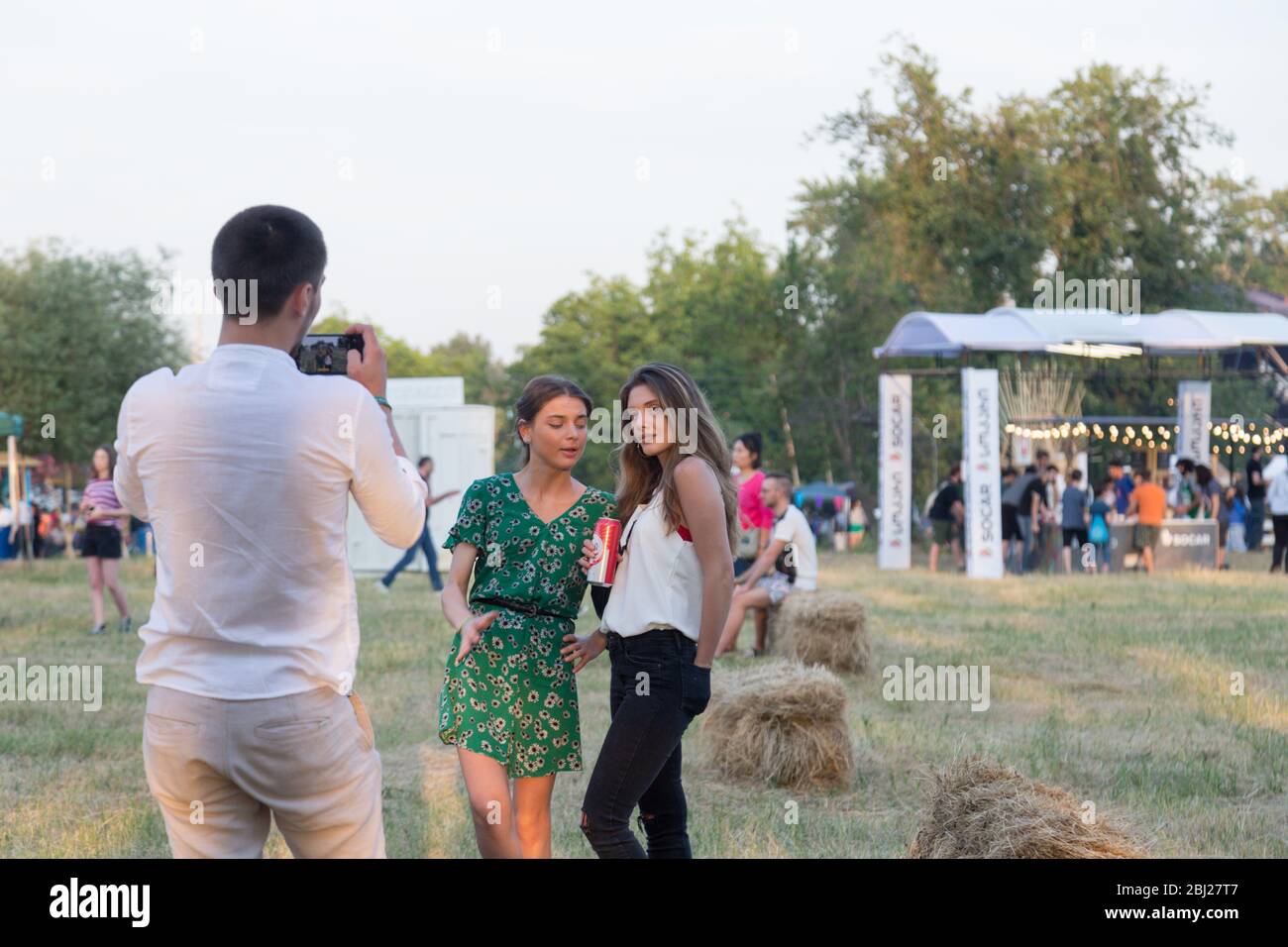 Audience with hands raised at a music festival and lights streaming ...