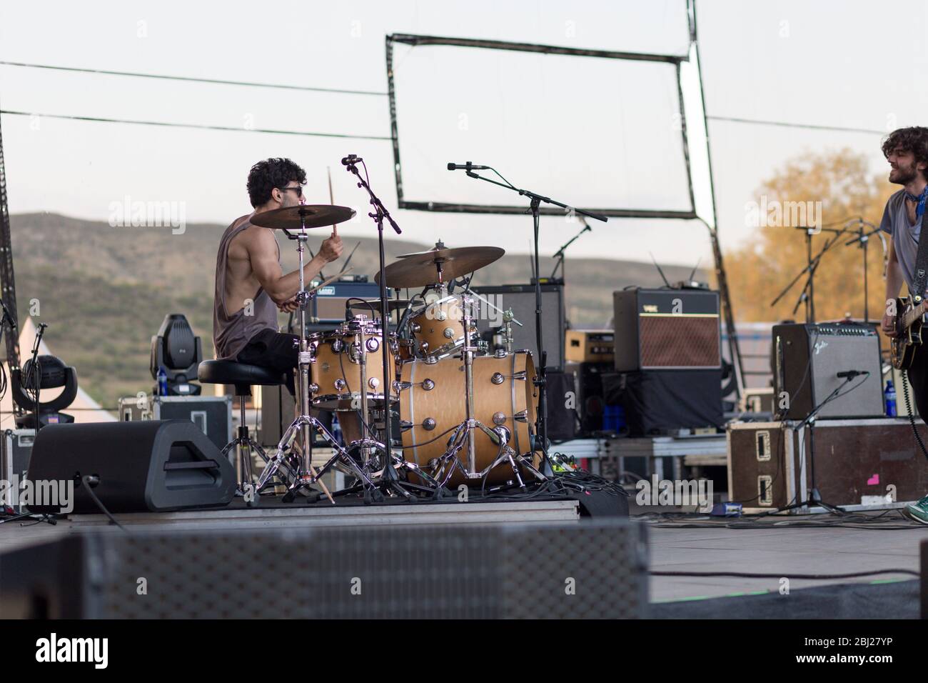 Audience with hands raised at a music festival and lights streaming ...