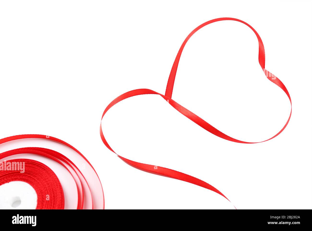 Red ribbon in shape of heart isolated on white Stock Photo - Alamy