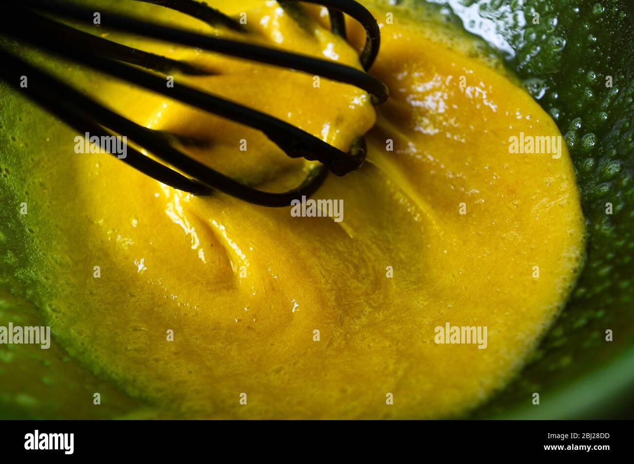 Mxing eggs with sugar , flour and butter to bake a cake Stock Photo - Alamy