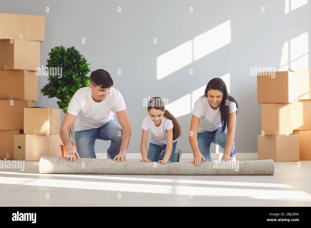 Happy family with children moving in a new apartment house Stock Photo ...