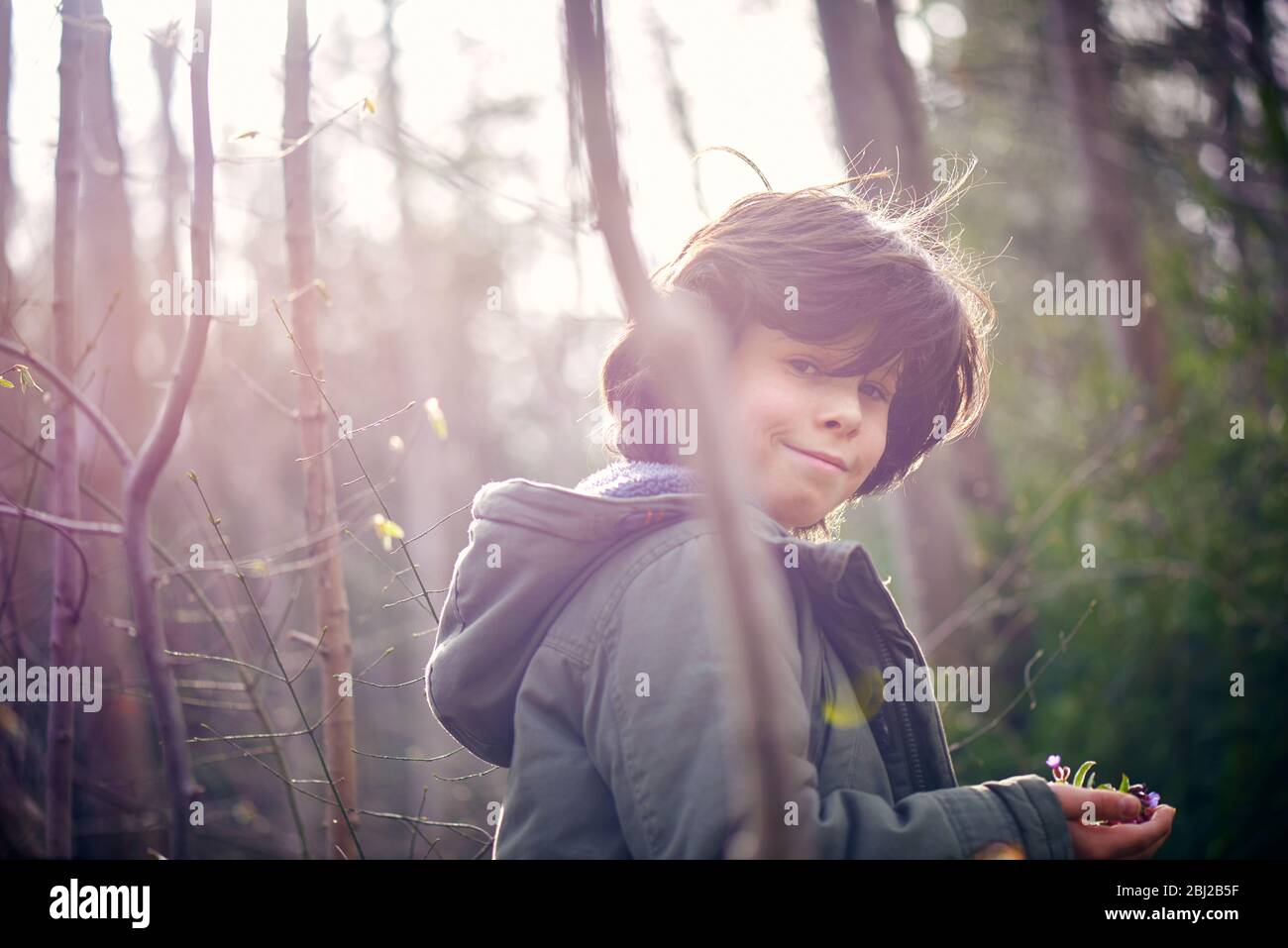 Young boy picks flowers for his loved ones Stock Photo - Alamy