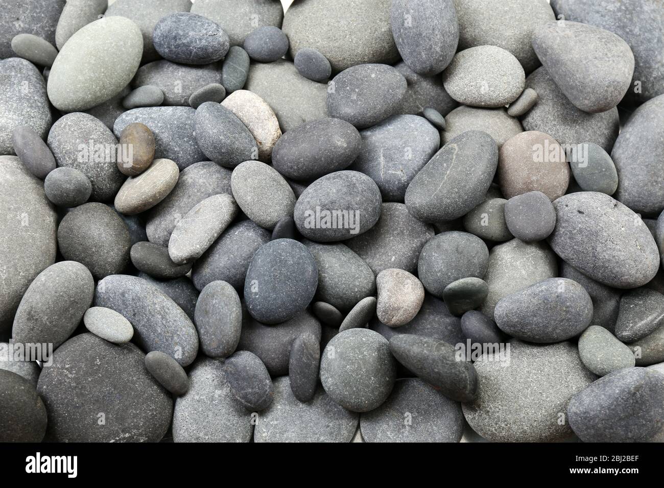 Gray sea pebbles background Stock Photo - Alamy