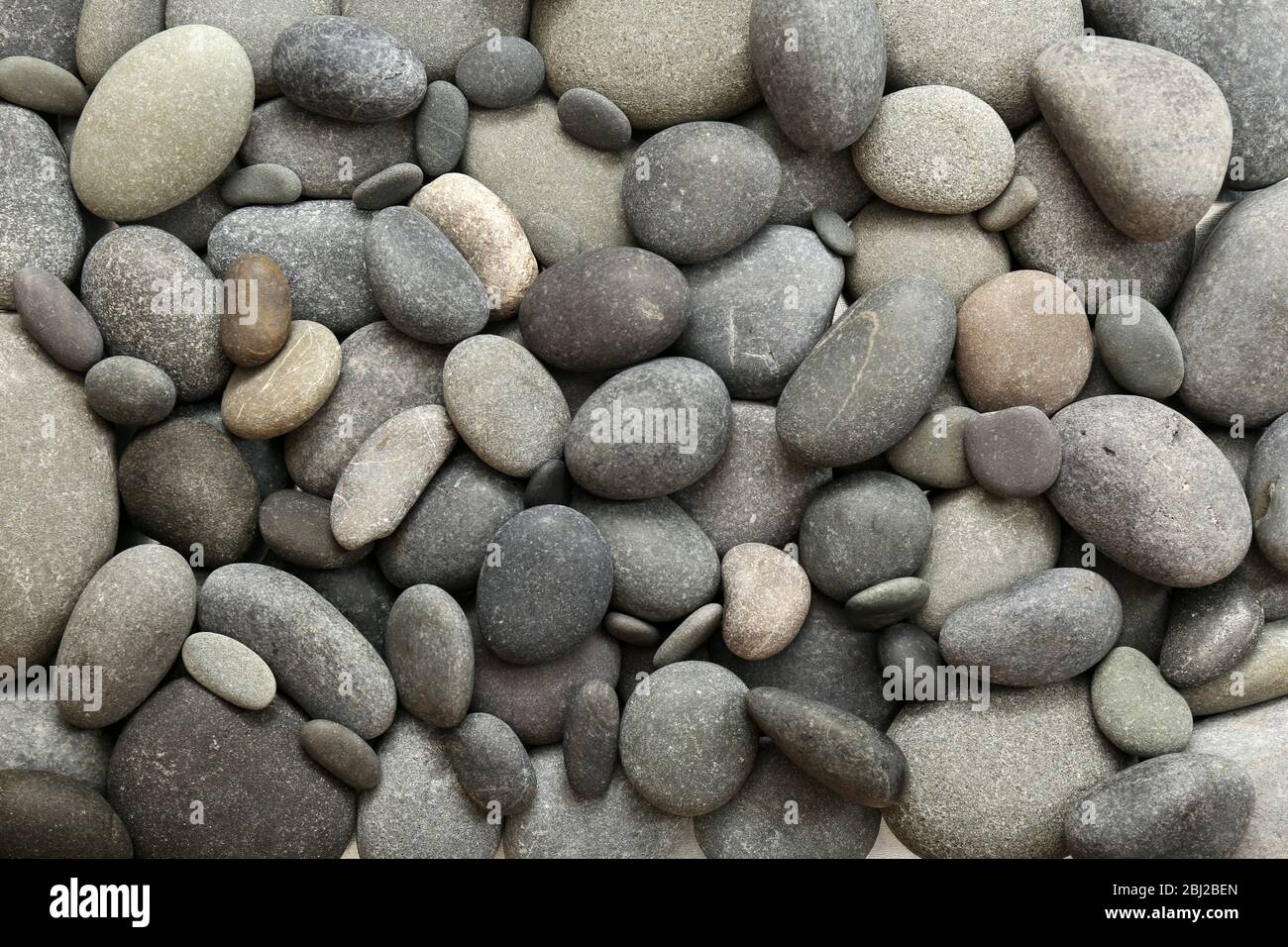 Gray sea pebbles background Stock Photo - Alamy