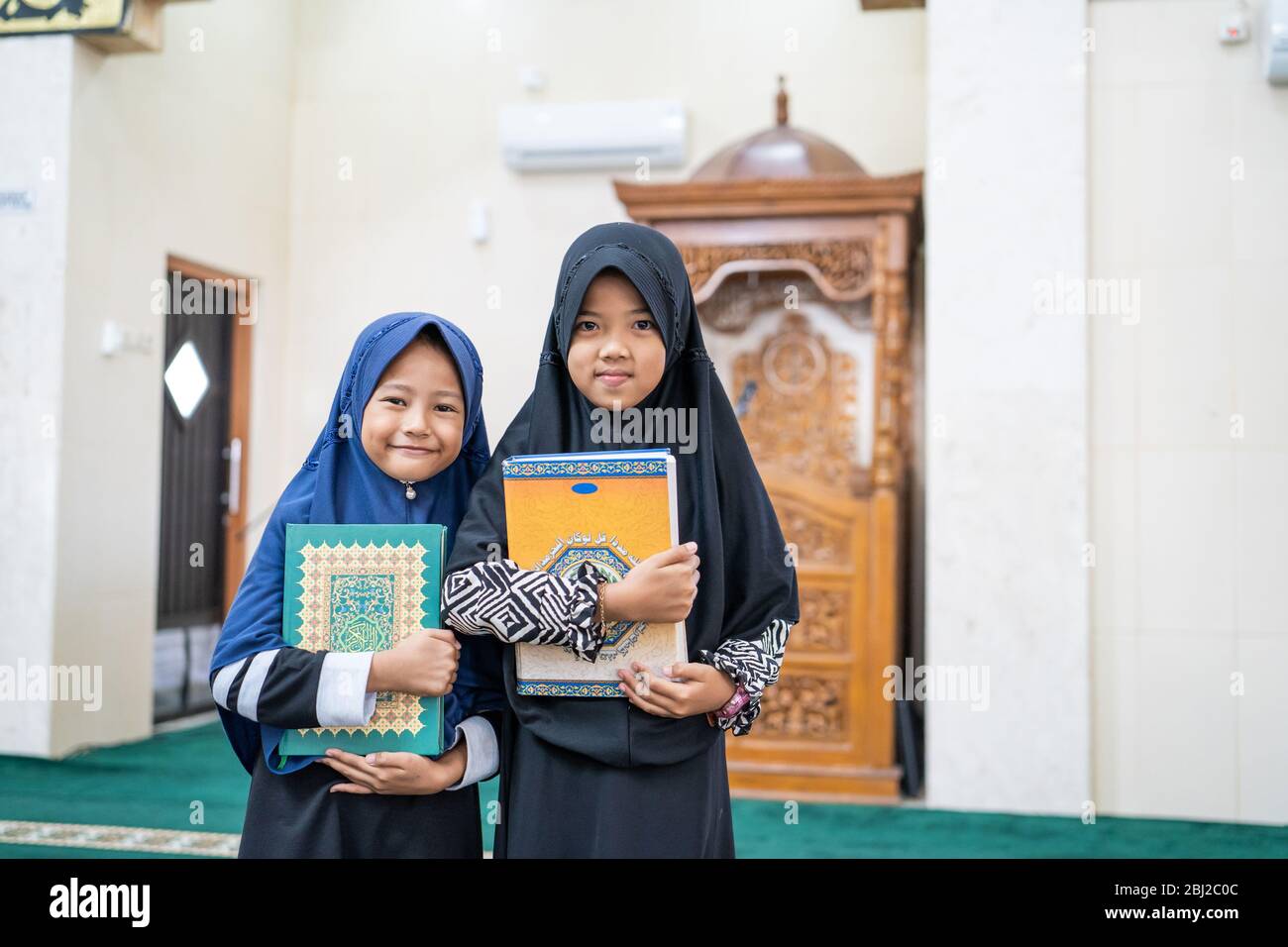 beautiful young kid holding quran praying in the mosque or masjid Stock ...