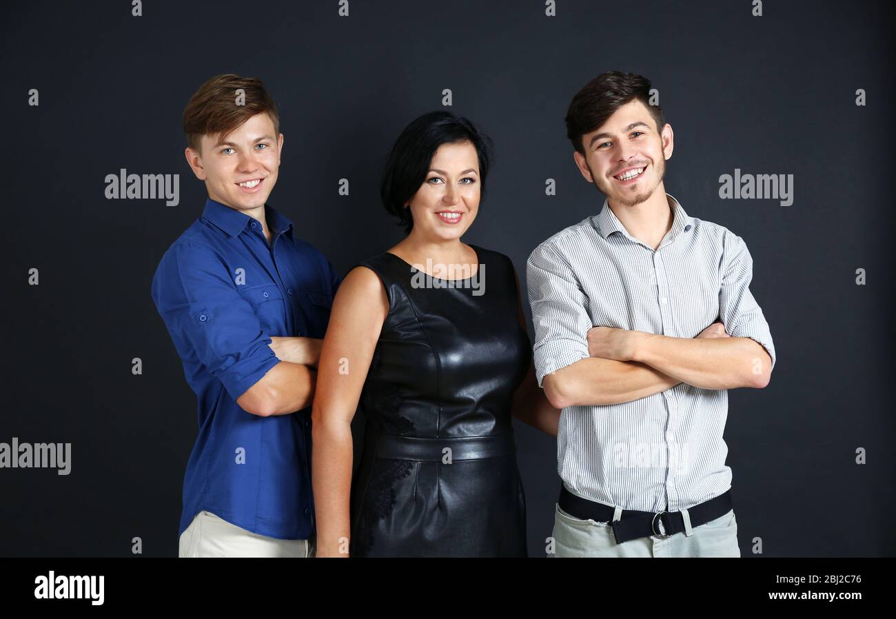 Portrait of mother and her sons on dark background Stock Photo - Alamy