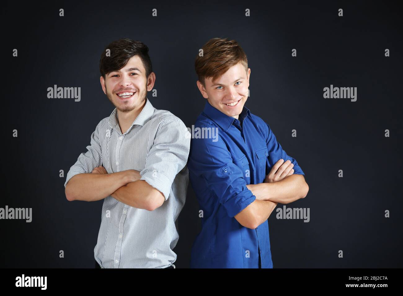 Two brothers on dark background Stock Photo - Alamy