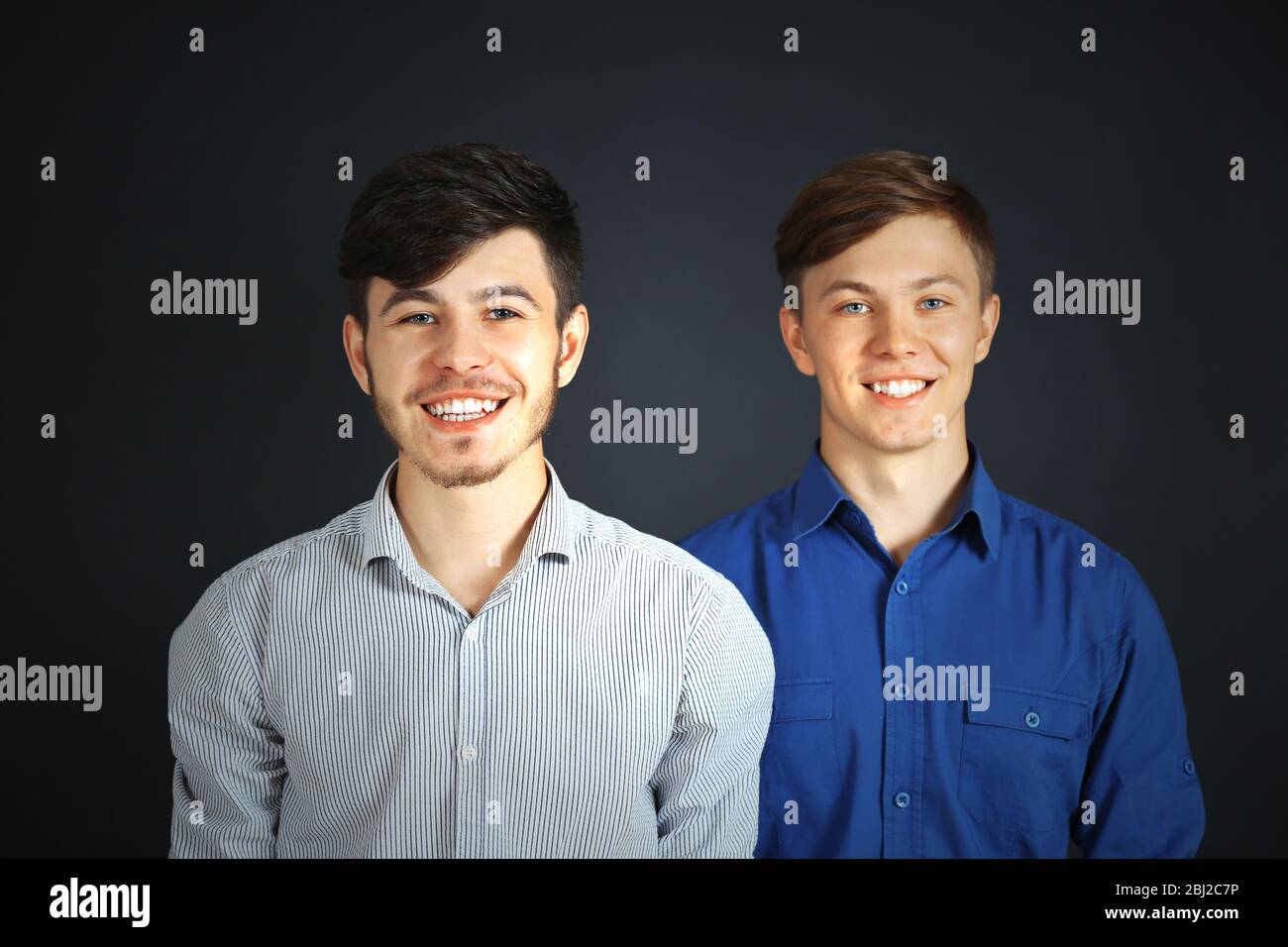 Two brothers on dark background Stock Photo - Alamy