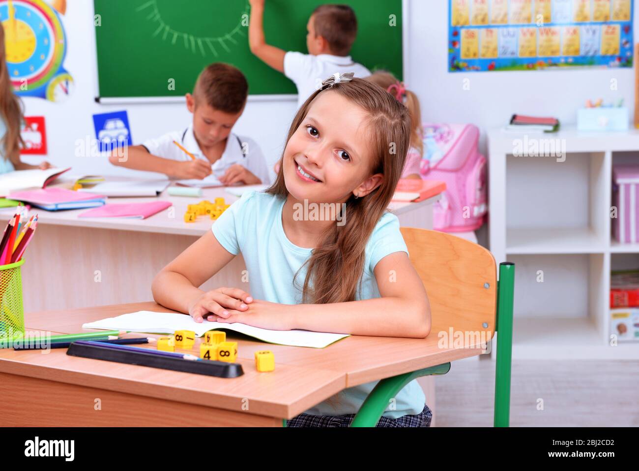 Children at the desks in classroom Stock Photo - Alamy