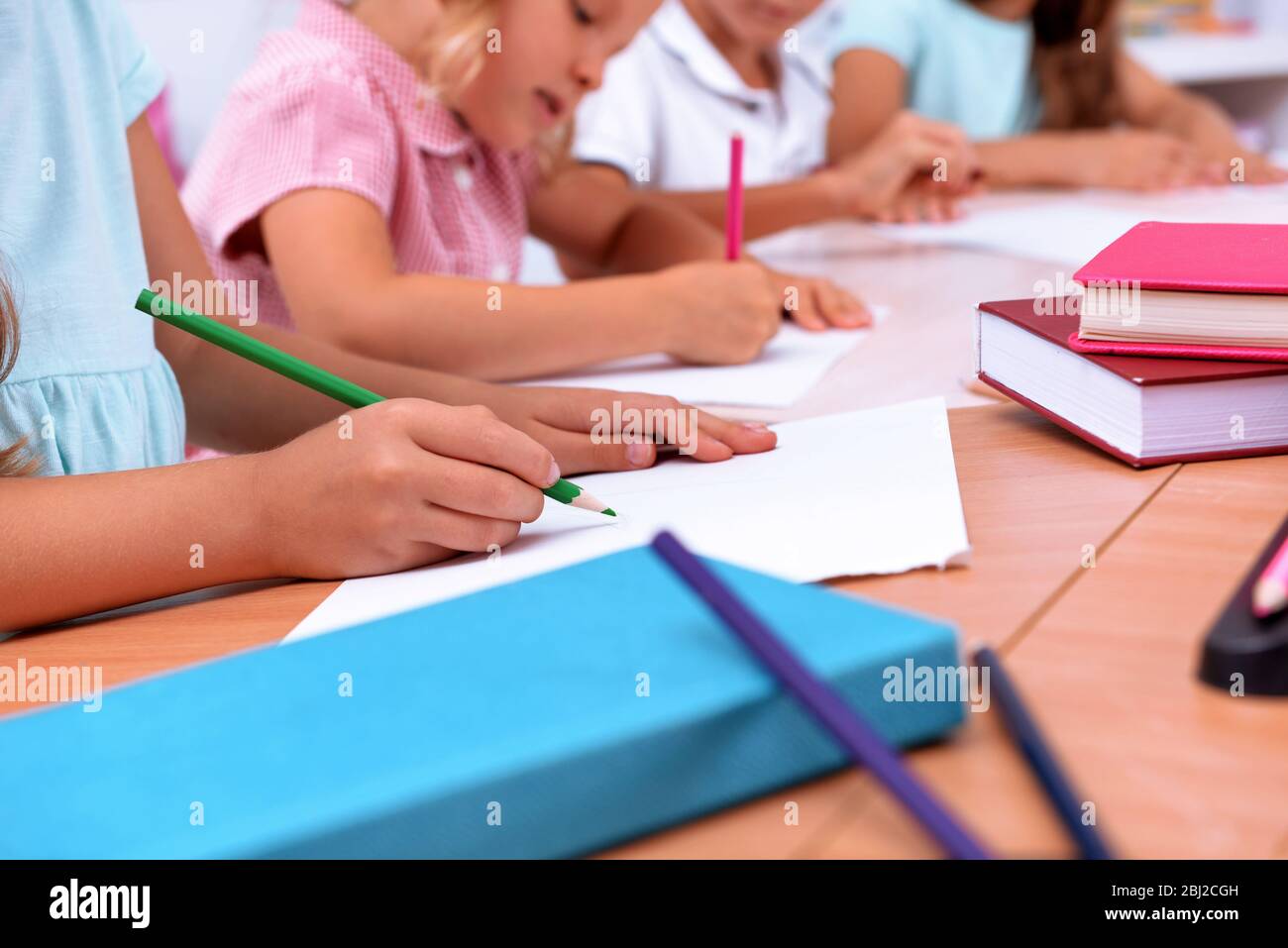 Group of children drawing at the desk, closeup Stock Photo - Alamy