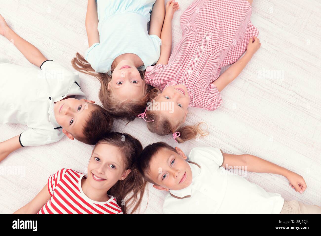 Top view of children in circle on floor Stock Photo - Alamy