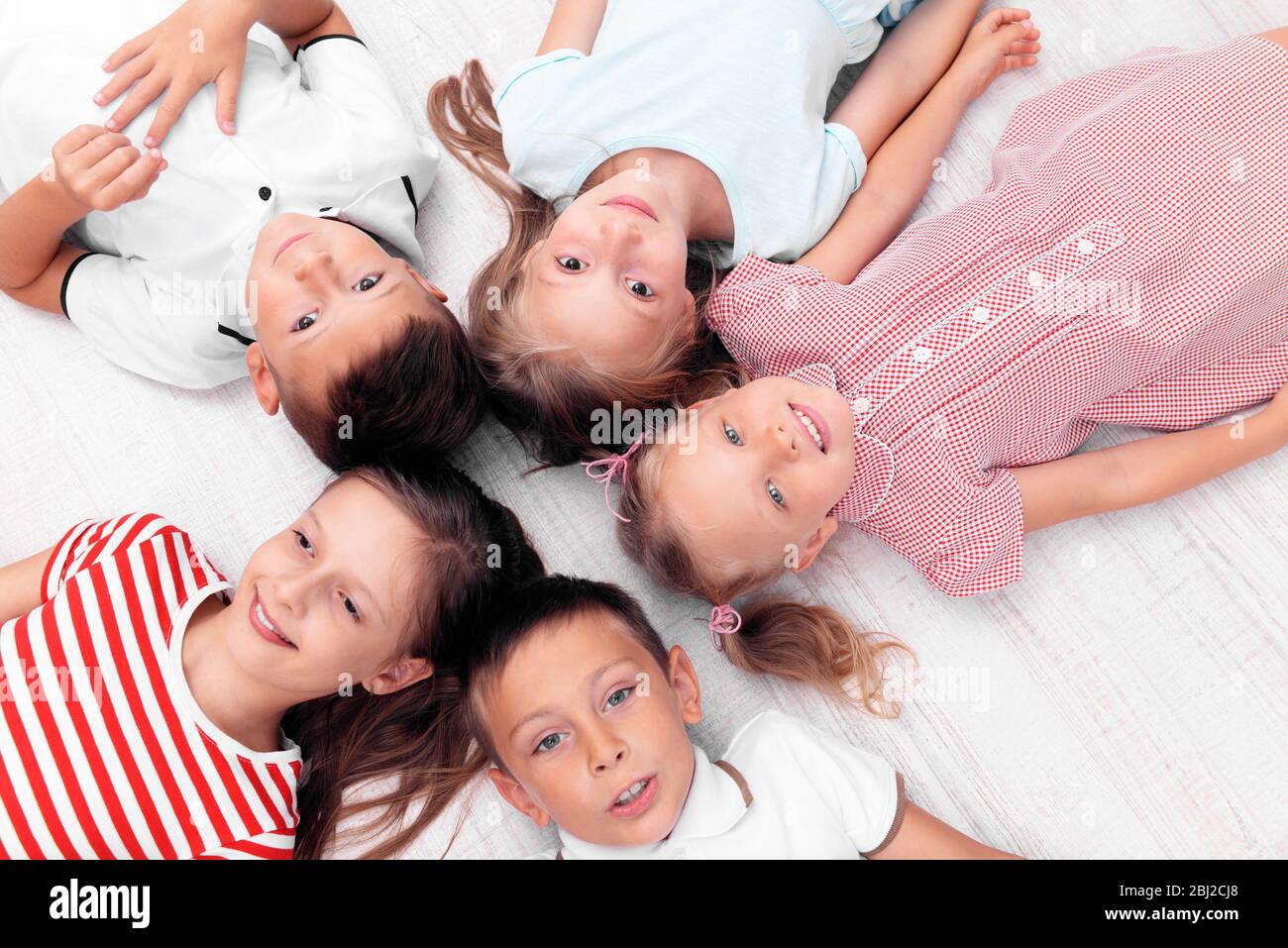 Top view of children in circle on floor Stock Photo - Alamy