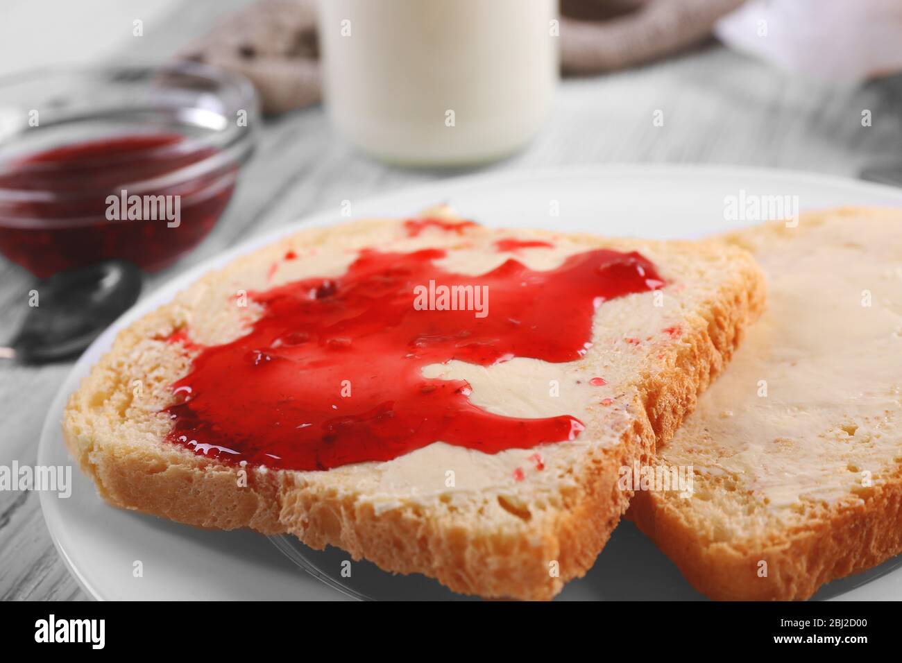 Bread with butter and homemade jam in plate, closeup Stock Photo - Alamy